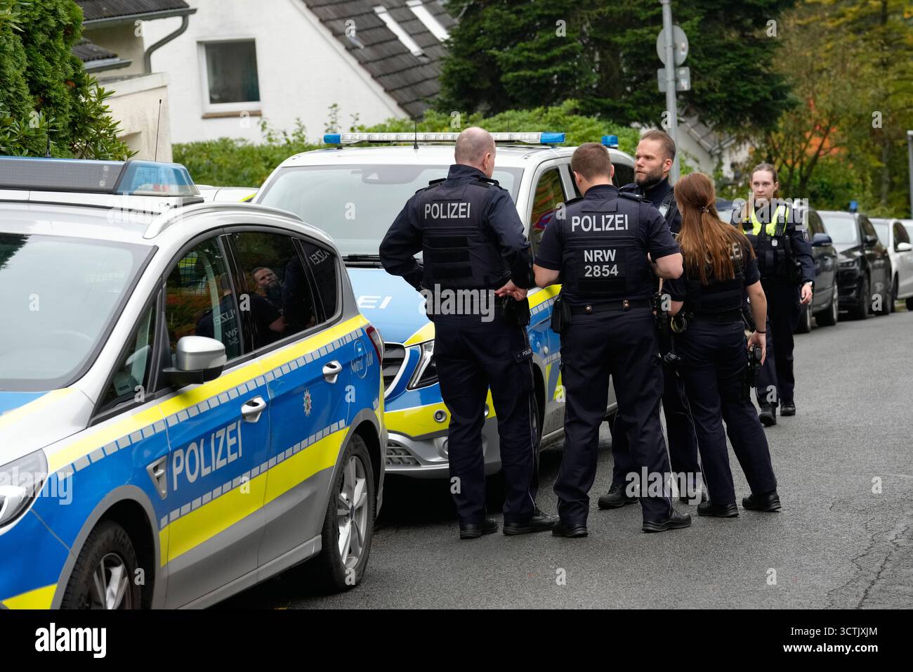 Police officers stand at a street in Herdecke, Germany, Tuesday, Oct. 7 ...