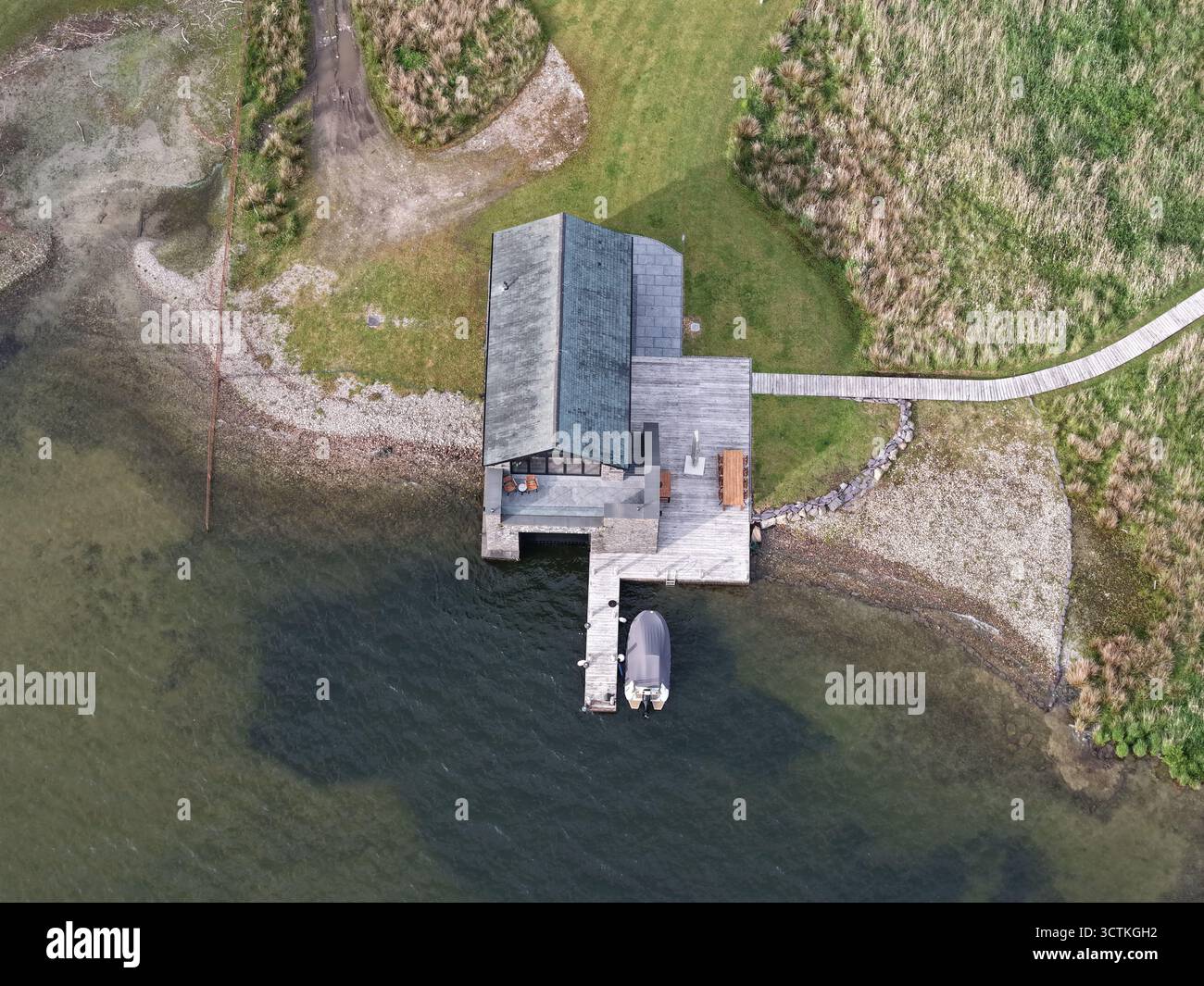 Cozy waterfront cabin with dock nestled in green landscape during ...