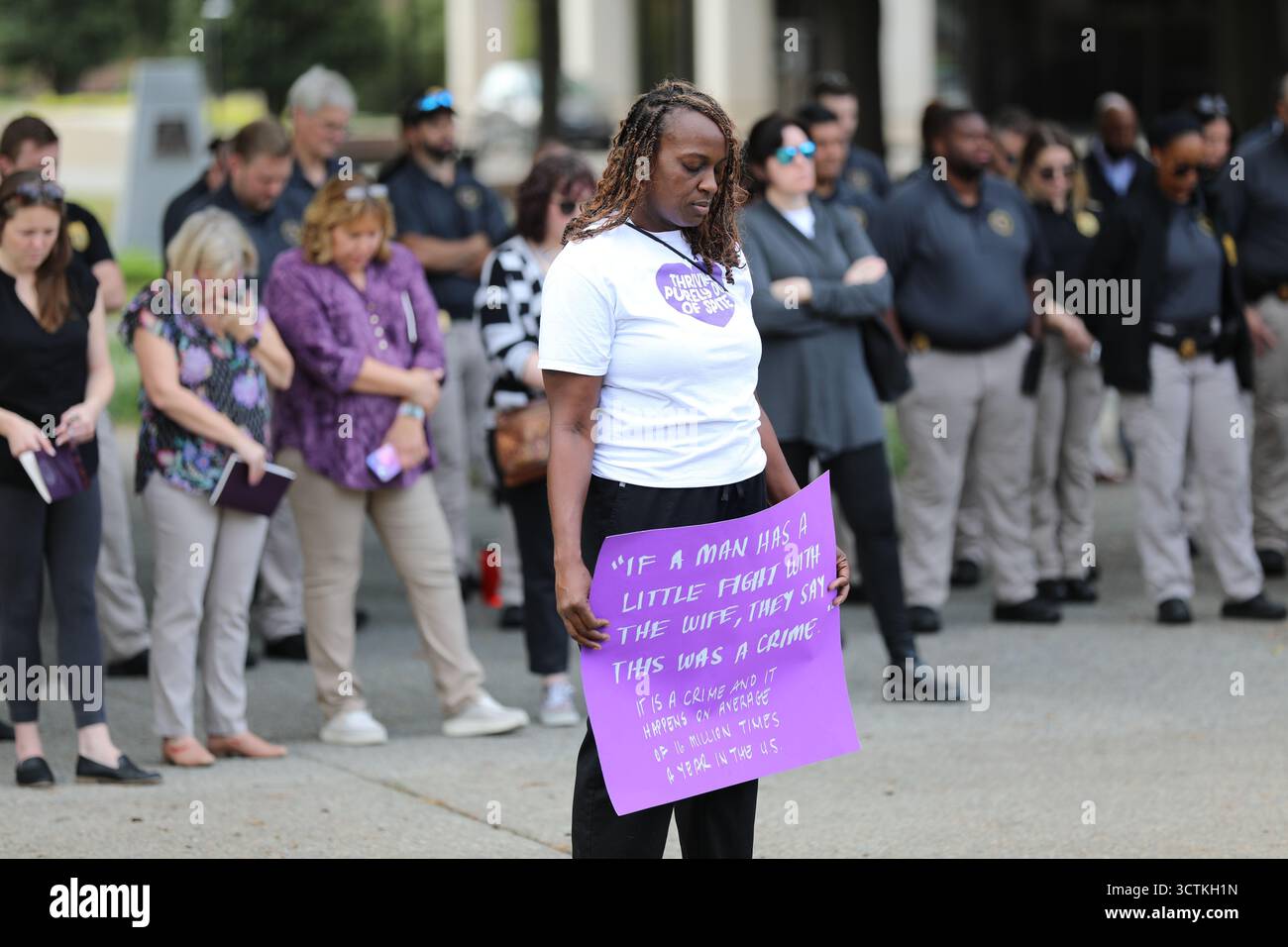A woman holds a sign during a moment of silence at the South Carolina ...