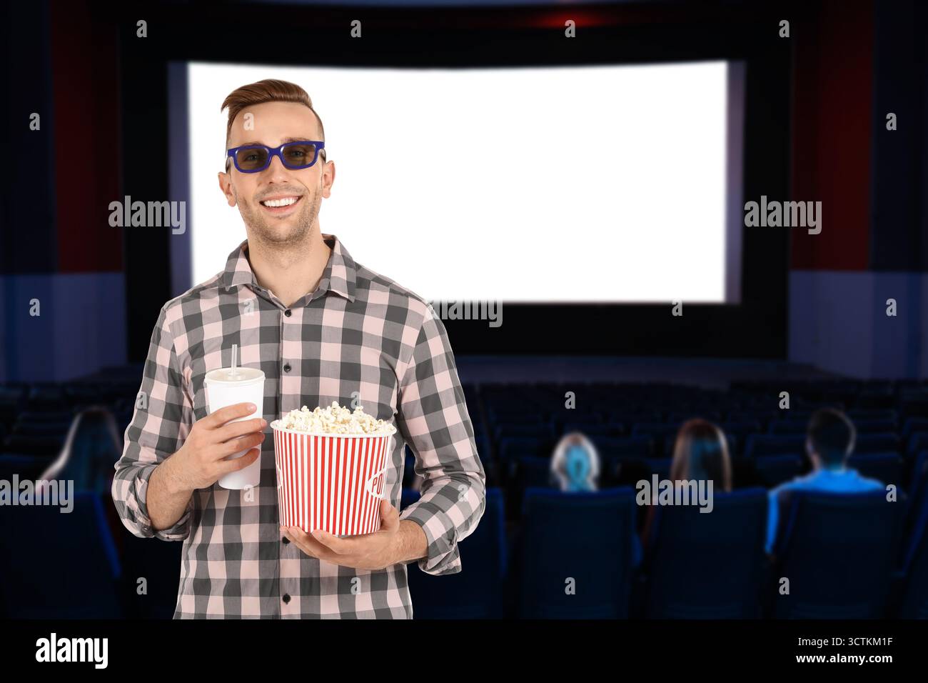Man with 3D glasses, beverage and popcorn in cinema Stock Photo - Alamy