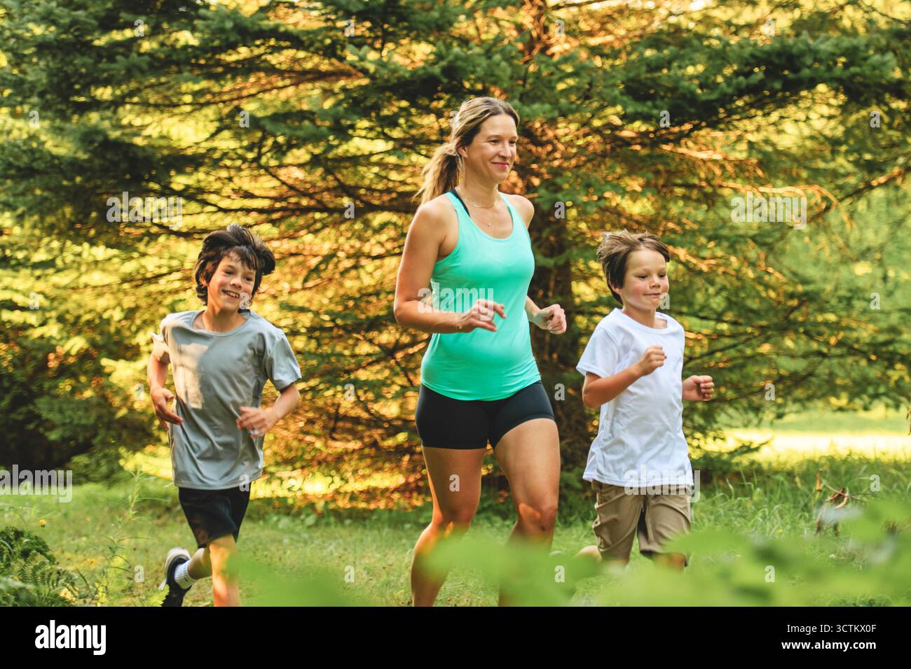 mother and son running outside in forest Stock Photo - Alamy
