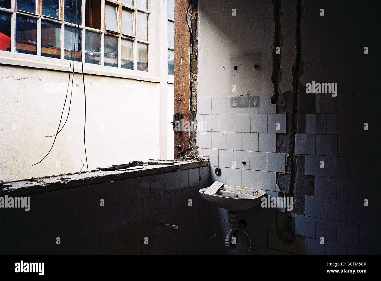 An old toilet inside a demolished factory, captured on analog film with ...