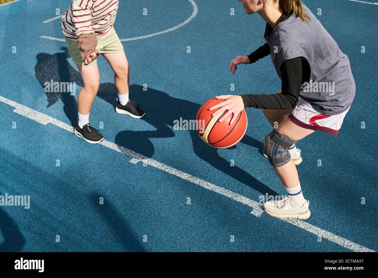 Boy dribbling basketball on outdoor court hi-res stock photography and ...