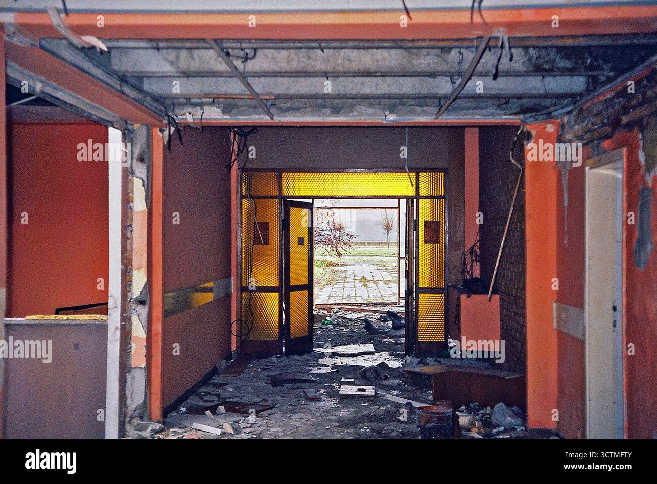 The exit of an abandoned factory undergoing demolition, with open doors ...