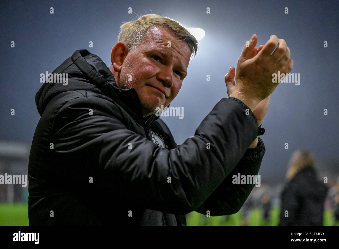 Pete Wild, manager of Fleetwood Town, applauds the home support during ...