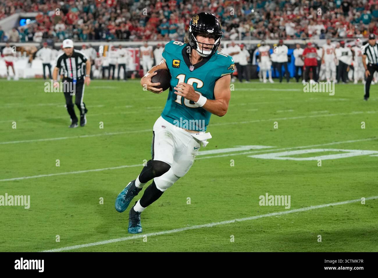 Jacksonville Jaguars quarterback Trevor Lawrence scrambles against the ...