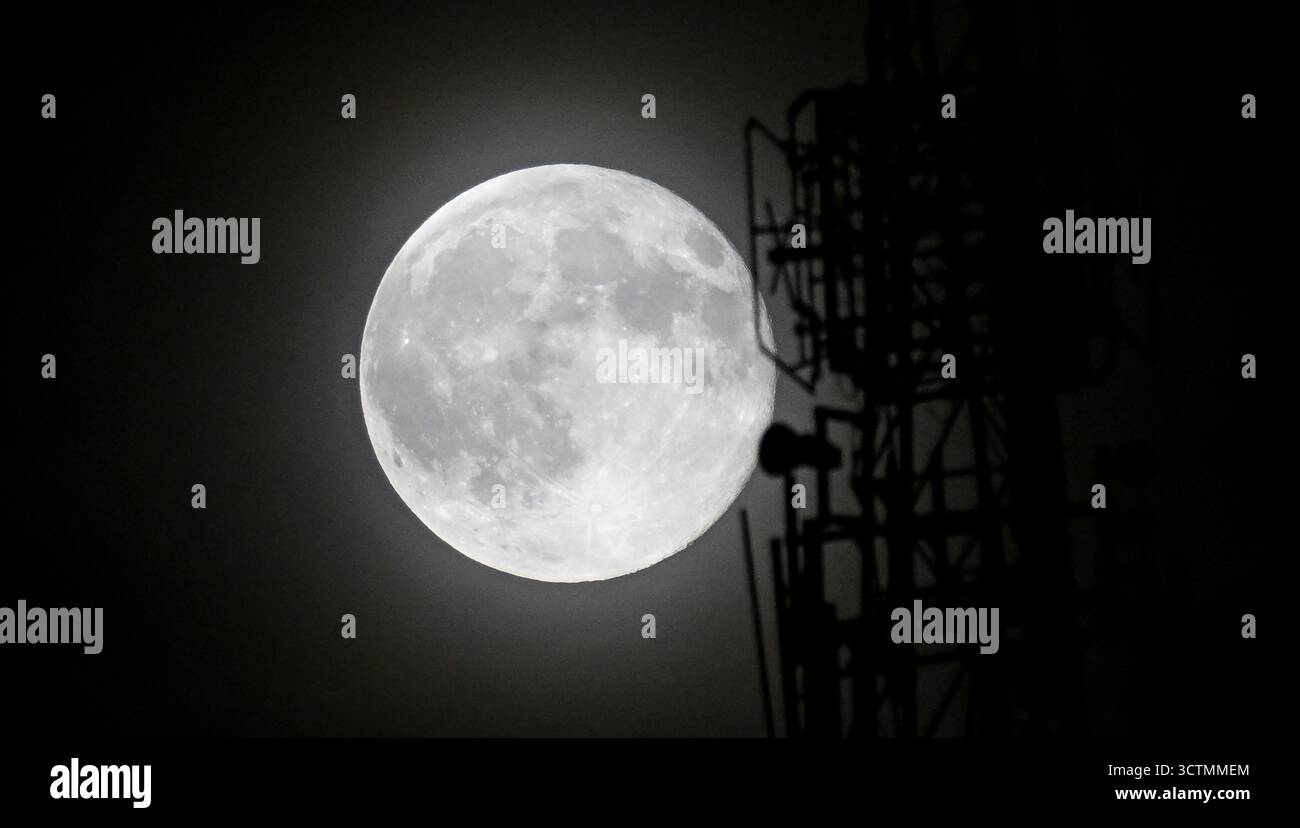 Brighton UK 7th October 2025 - The Harvest Moon rises behind the ...