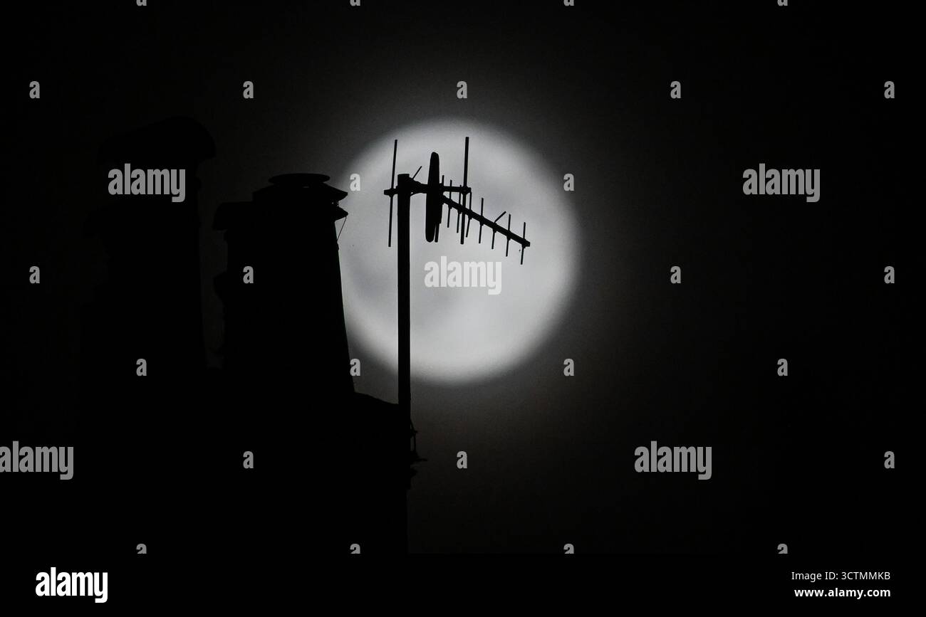 Brighton UK 7th October 2025 - The Harvest Moon rises behind the ...