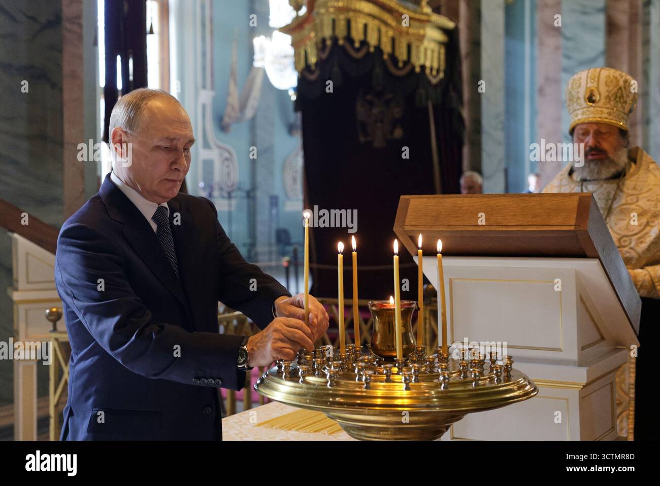 Russian President Vladimir Putin lights a candle in the Peter and Paul ...