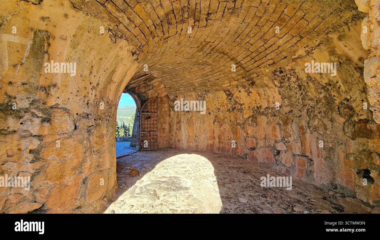 Curved vaulted arched passage in historic stone venetian Assos Castle ...