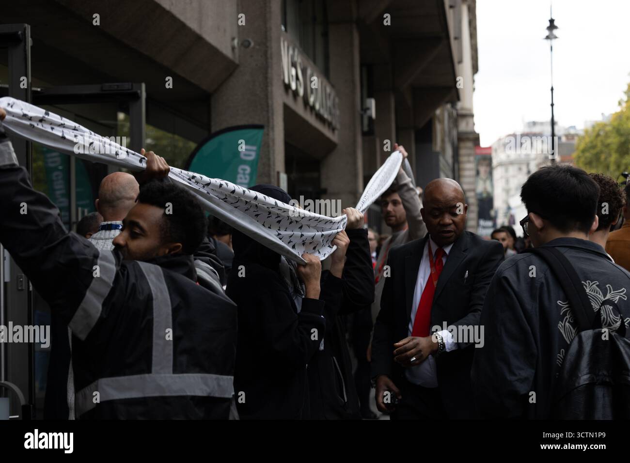 Students stretch a banner containing the names of all the children ...