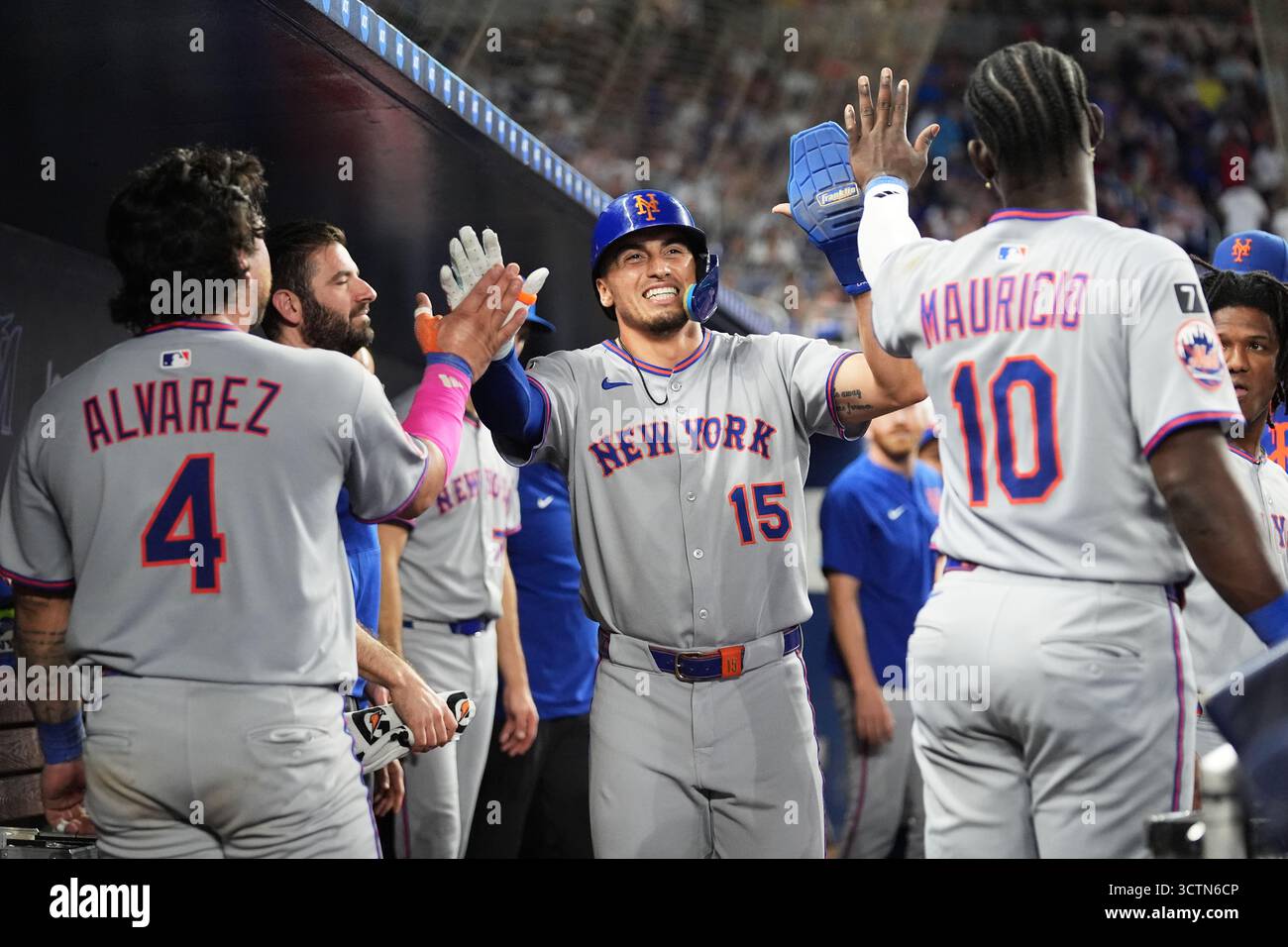 New York Mets' Tyrone Taylor (15) is congratulated after scoring on a ...