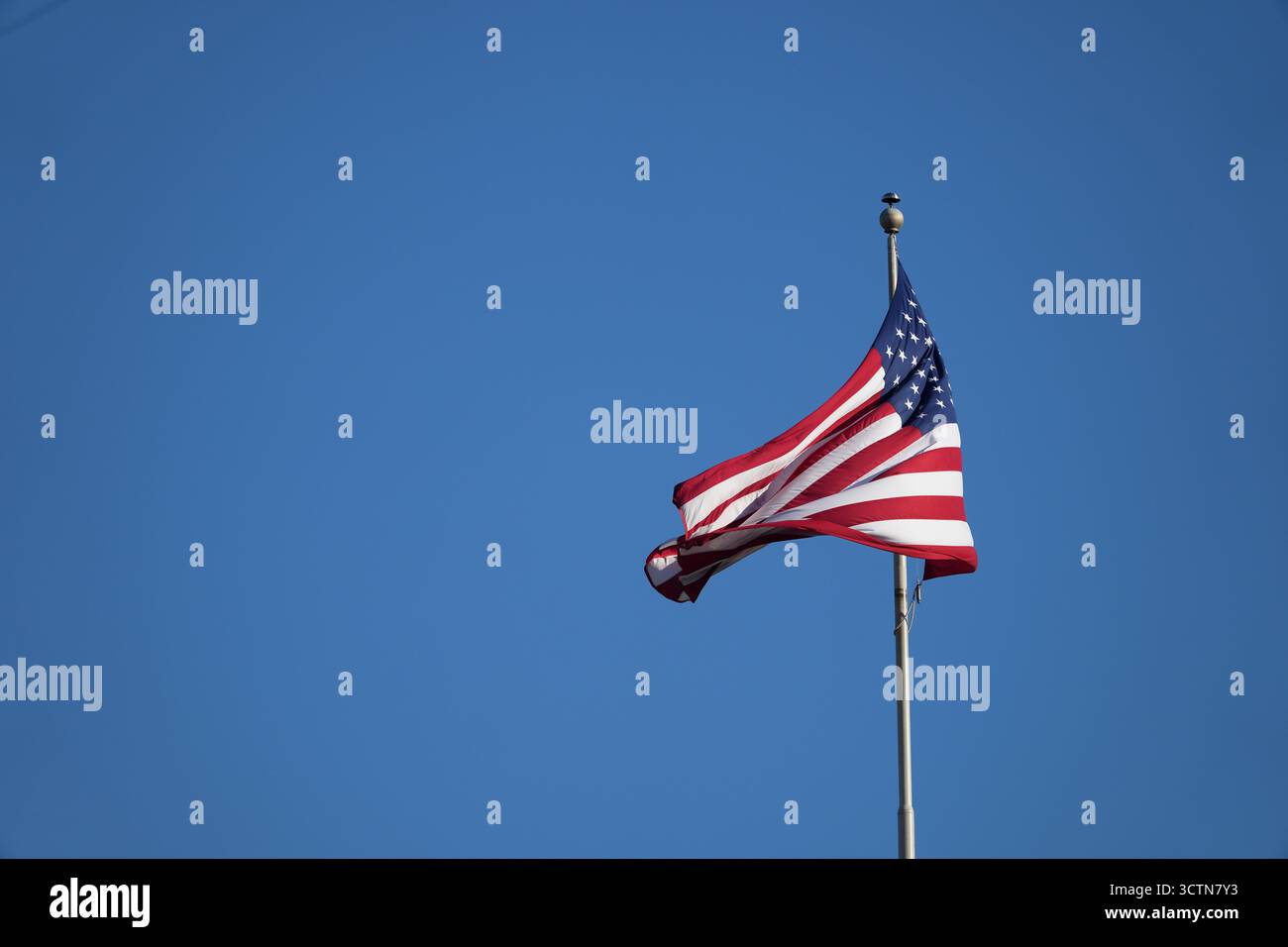 An American flag is seen atop a flag pole during an NFL football game ...