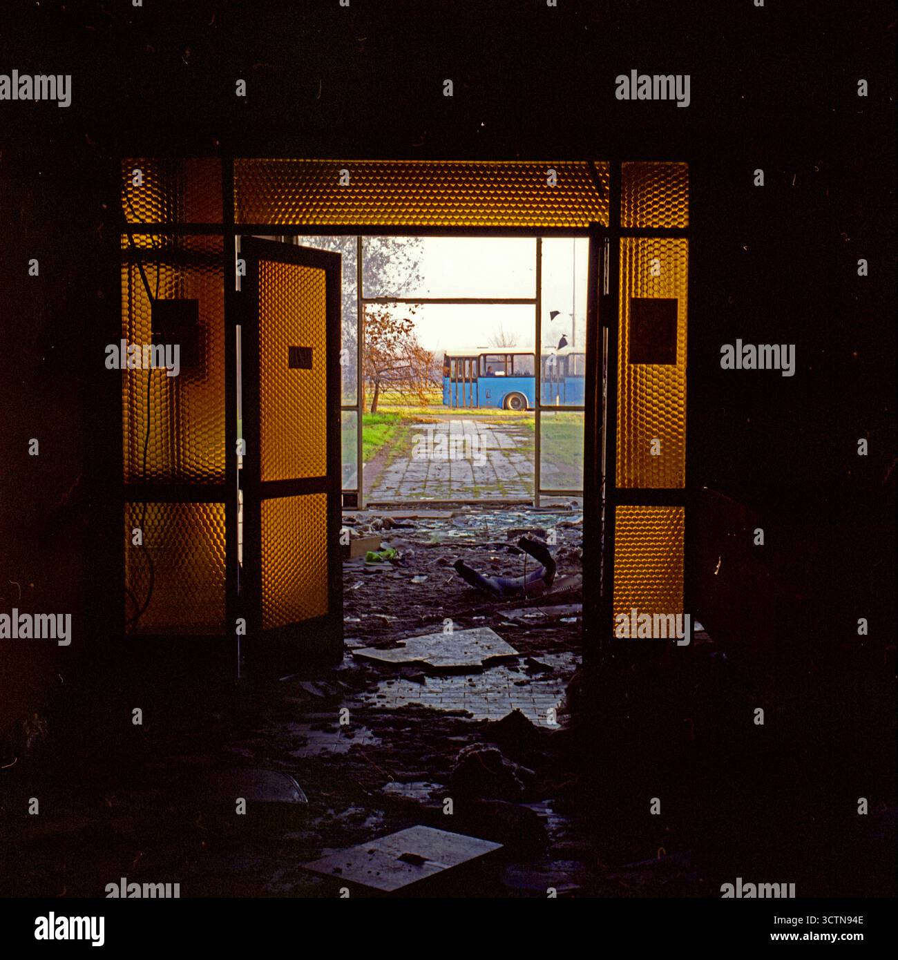 Color medium format analog photo of an abandoned factory exit with ...
