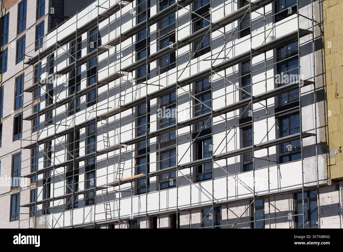 Scaffolding at the facade of a building under construction. Industry ...
