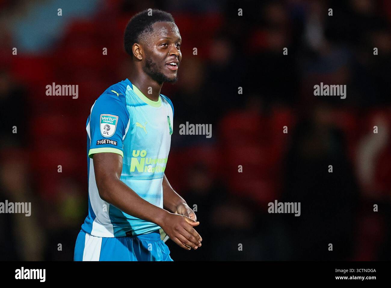 11, Kamarai Simon-Swyer of Northampton Town heads back for the restart ...