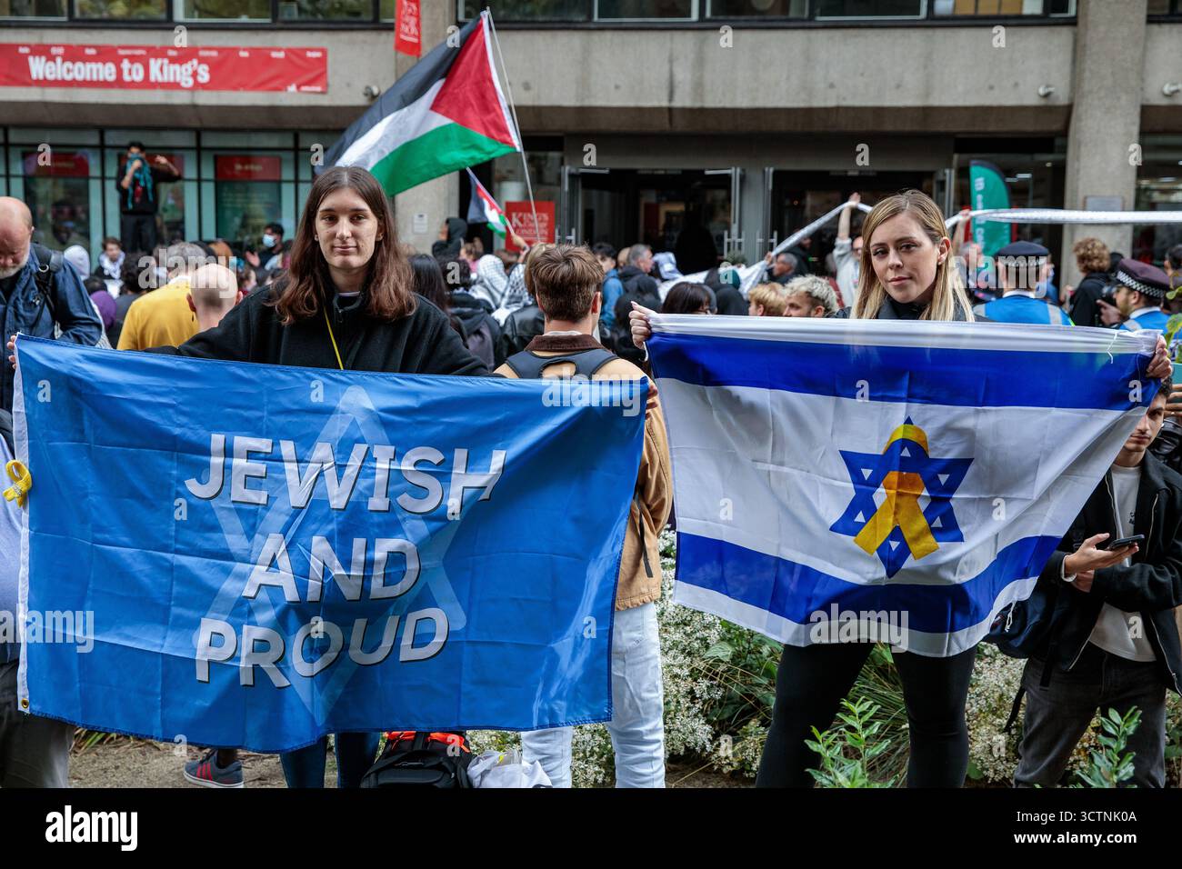 London, UK. 7th October, 2025. Two Jewish students holding flags stage ...