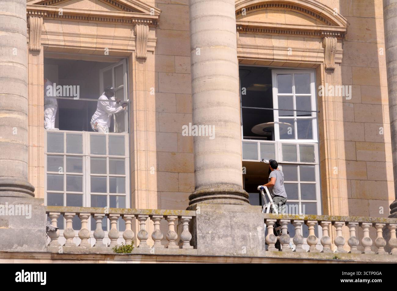 Men painting the window frames of the Chateau de Versailles (Palace of ...