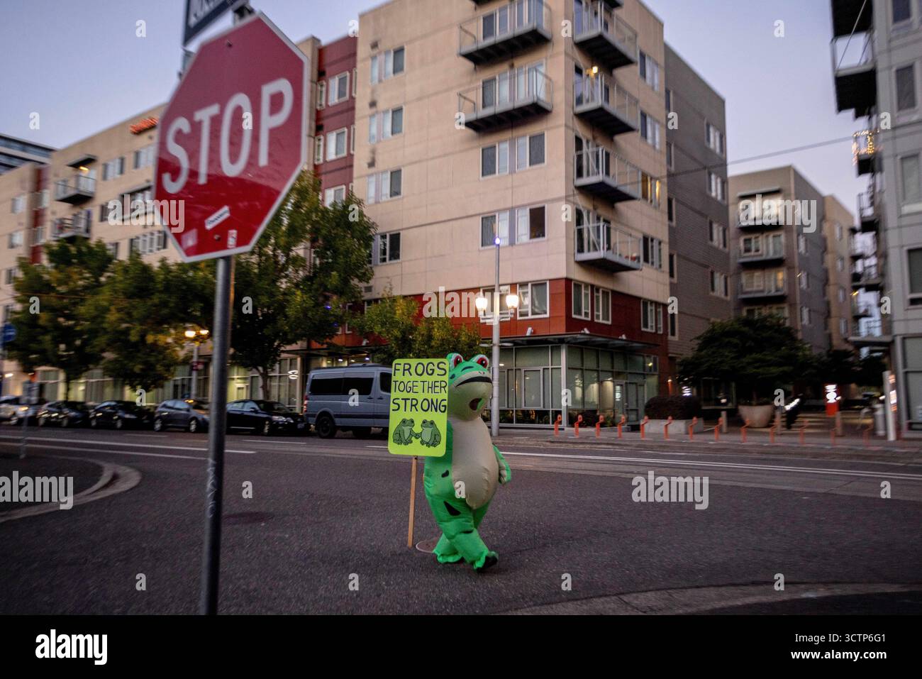 A protester in a frog costume walks toward a United States Immigration ...