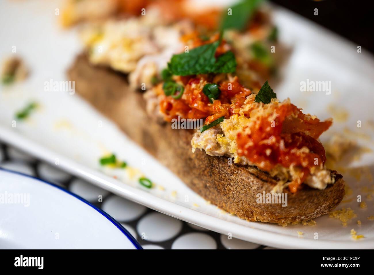 fried calf's brain with egg and kimchi served on toasted bread Stock ...