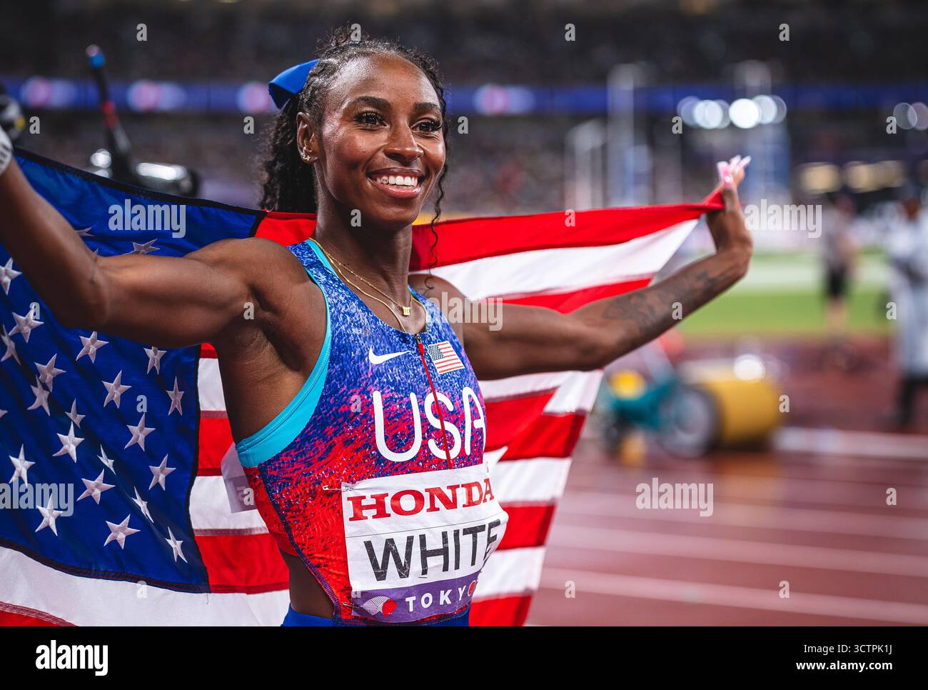 Kayla White celebrating her victory with her country's flag at the 2025 ...