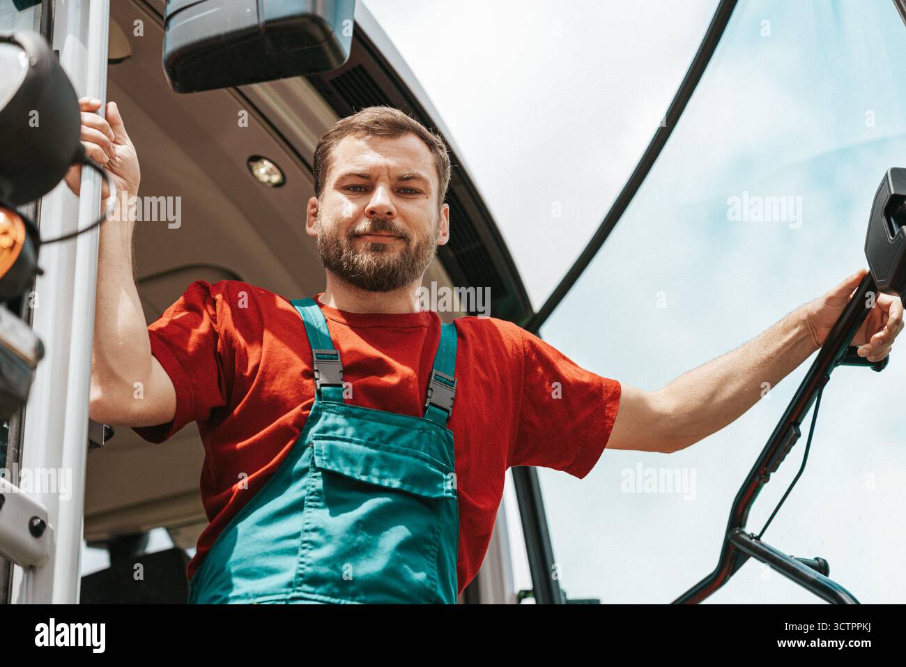 Low angle portrait of tractor driver outdoors in summer Stock Photo - Alamy