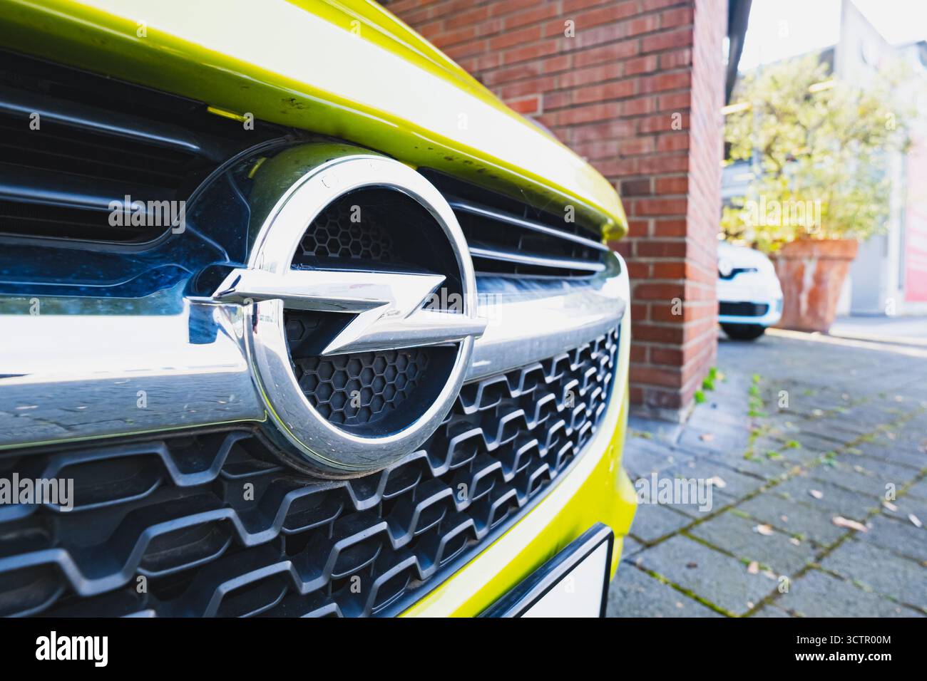 Opel badge logo on the front of a car outside of the dealership Stock ...