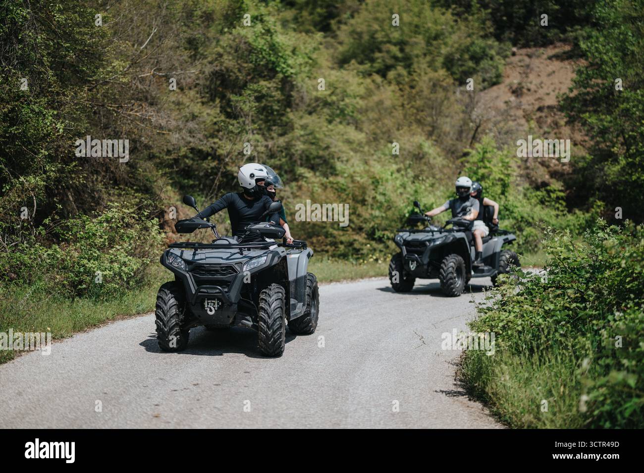Group friends driving quad bikes hi-res stock photography and images ...