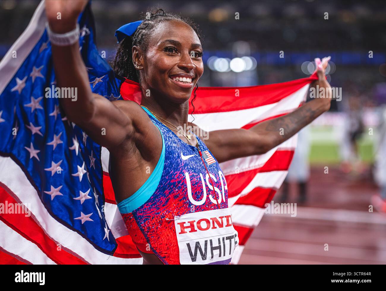 Kayla White celebrating her victory with her country's flag at the 2025 ...