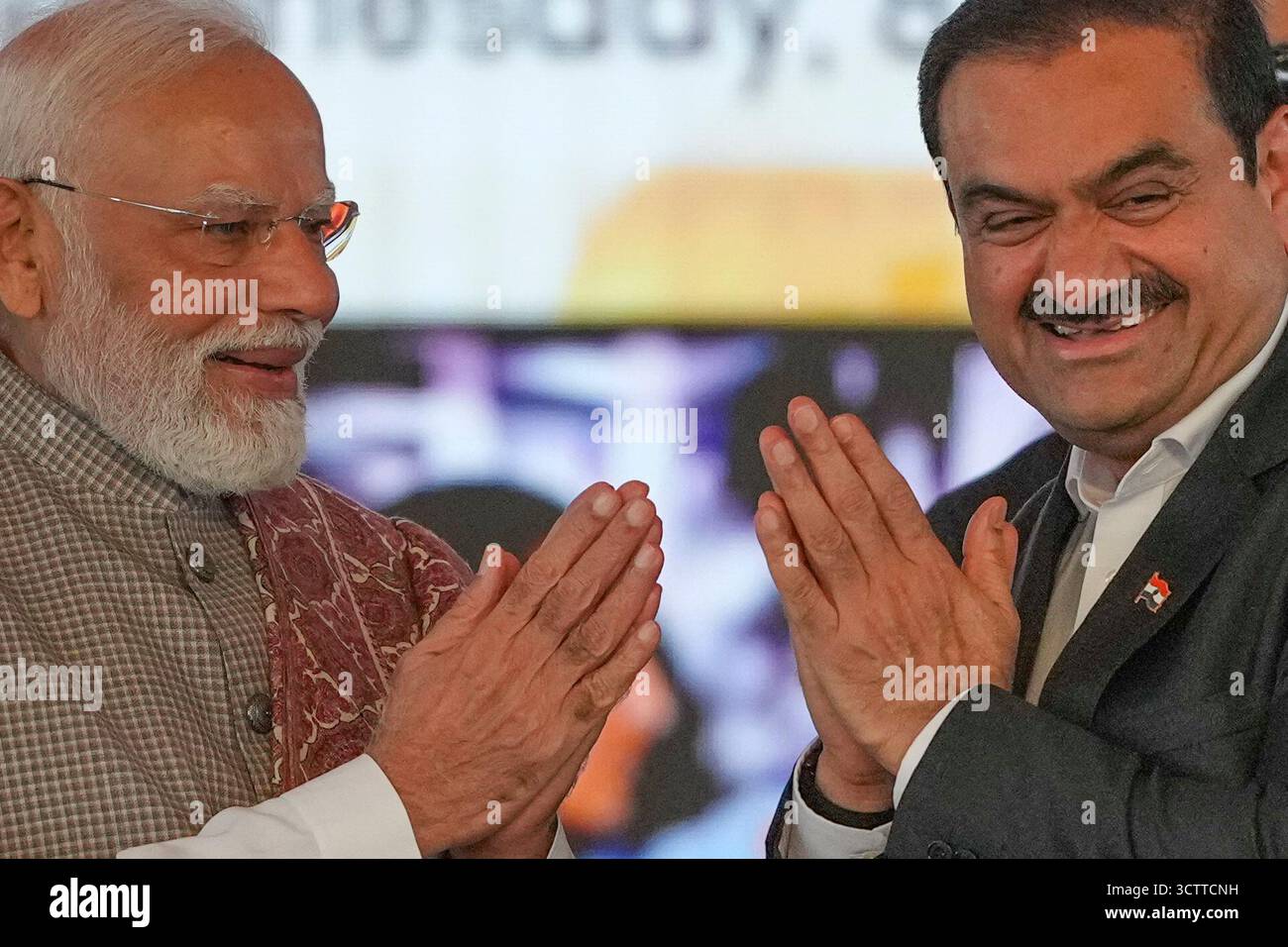 Indian Prime Minister Narendra Modi, left, greets Chairman Adani Group ...