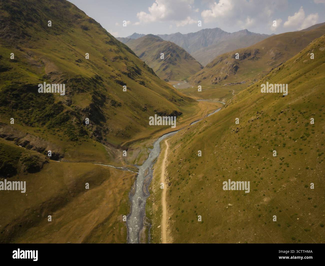 Aerial view of a winding river cutting through the rugged, grassy ...