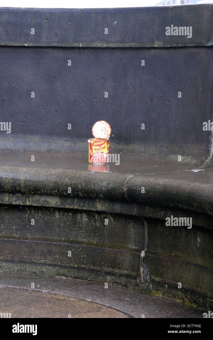 An open, half-eaten can of Maggi ravioli as an urban still life, left ...