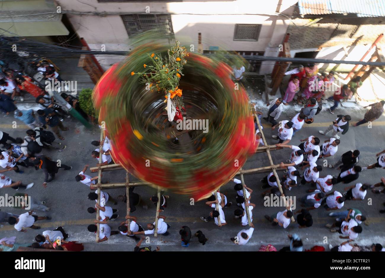 Kathmandu, Nepal. 8th Oct, 2025. Local people rotate the traditional ...