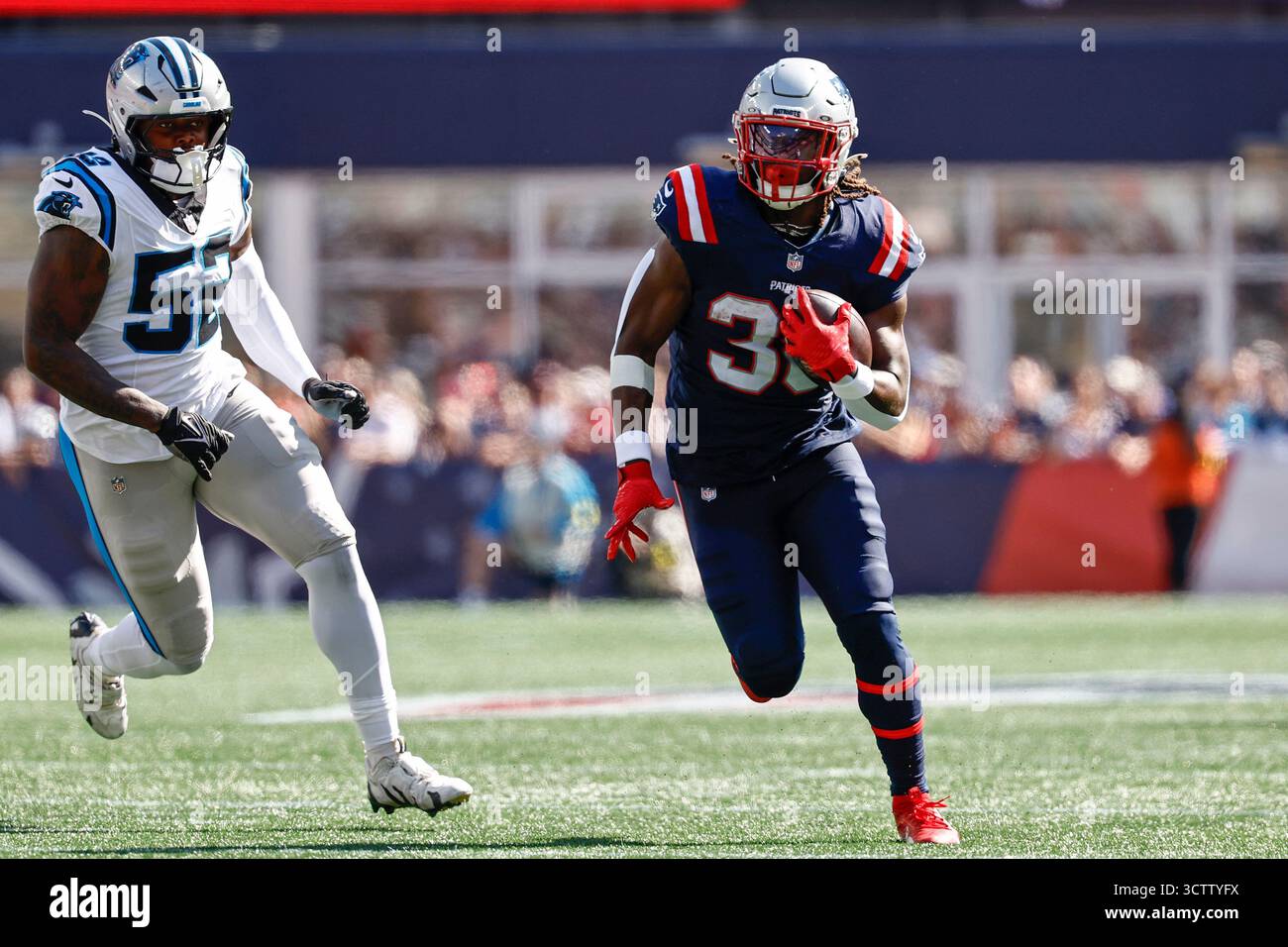 New England Patriots' Rhamondre Stevenson runs against the Carolina ...