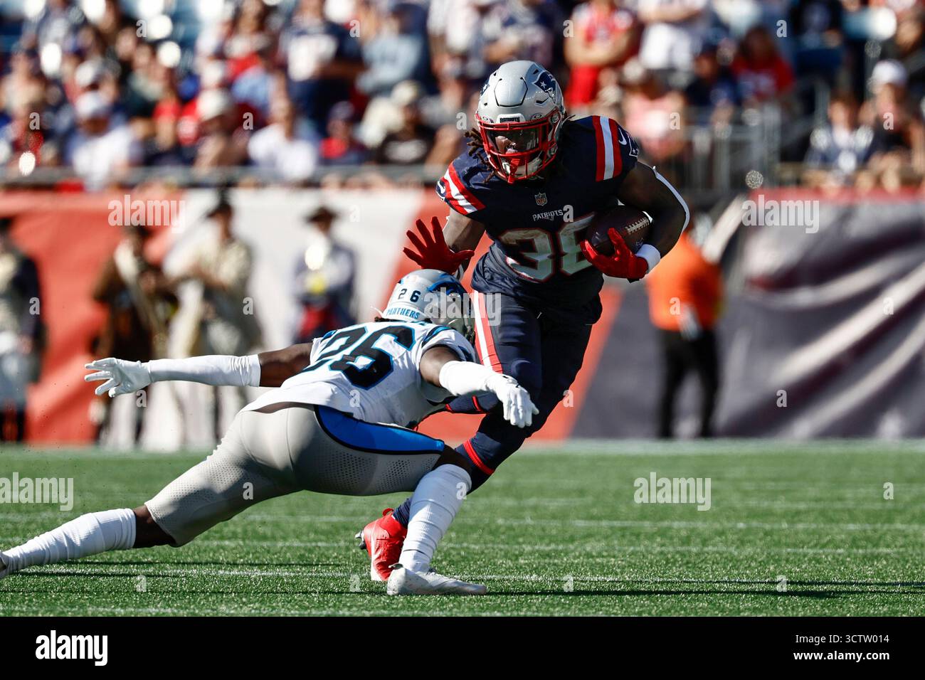 New England Patriots' Rhamondre Stevenson runs against the Carolina ...