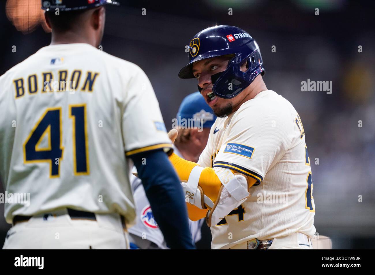 Milwaukee Brewers' William Contreras, right, reacts to hitting a single ...