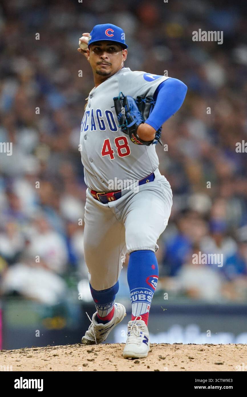 Chicago Cubs pitcher Daniel Palencia attempts to pick off the runner on ...