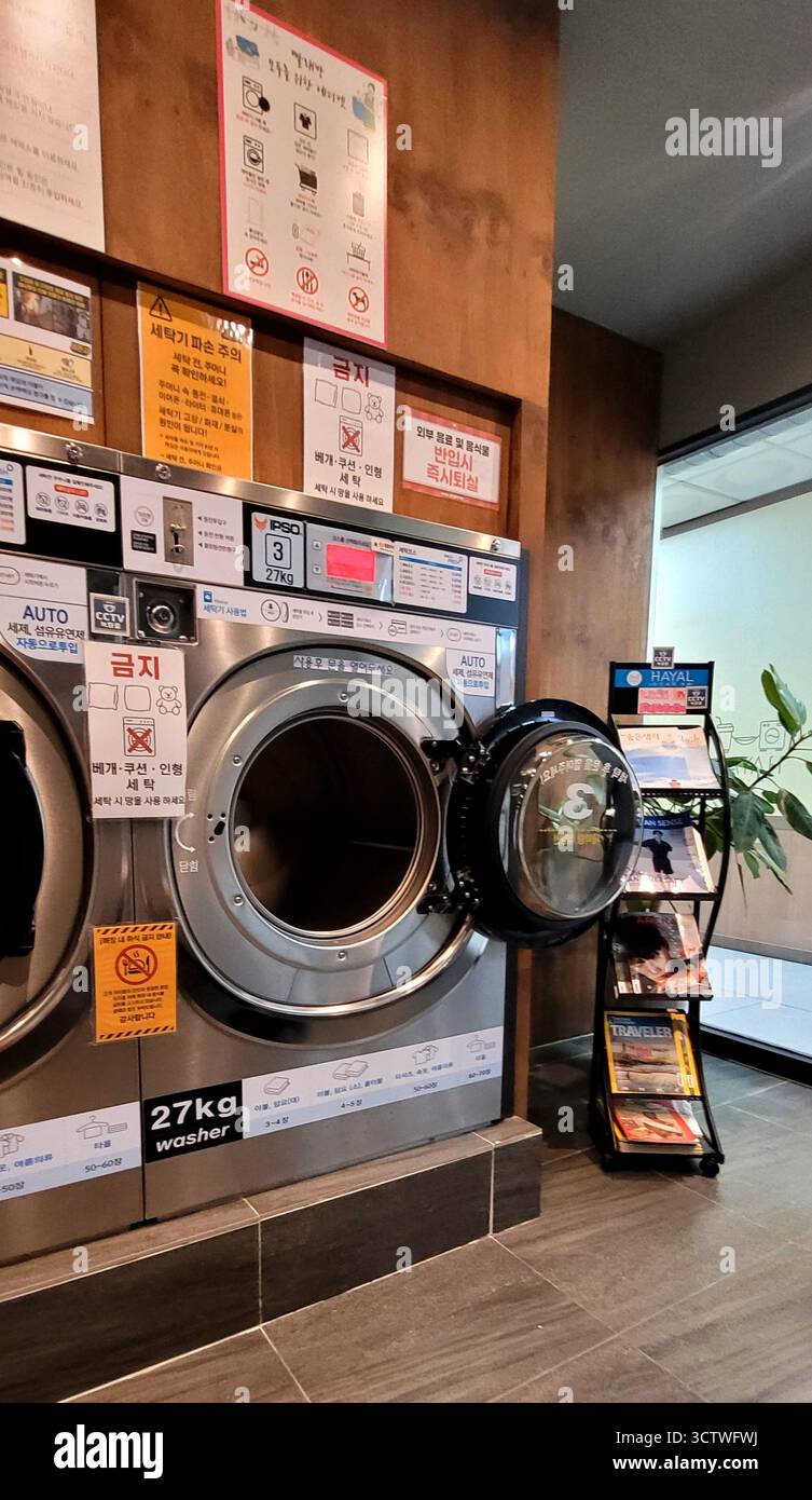 A photograph of a 24-hour launderette in Busan, South Korea, featuring ...