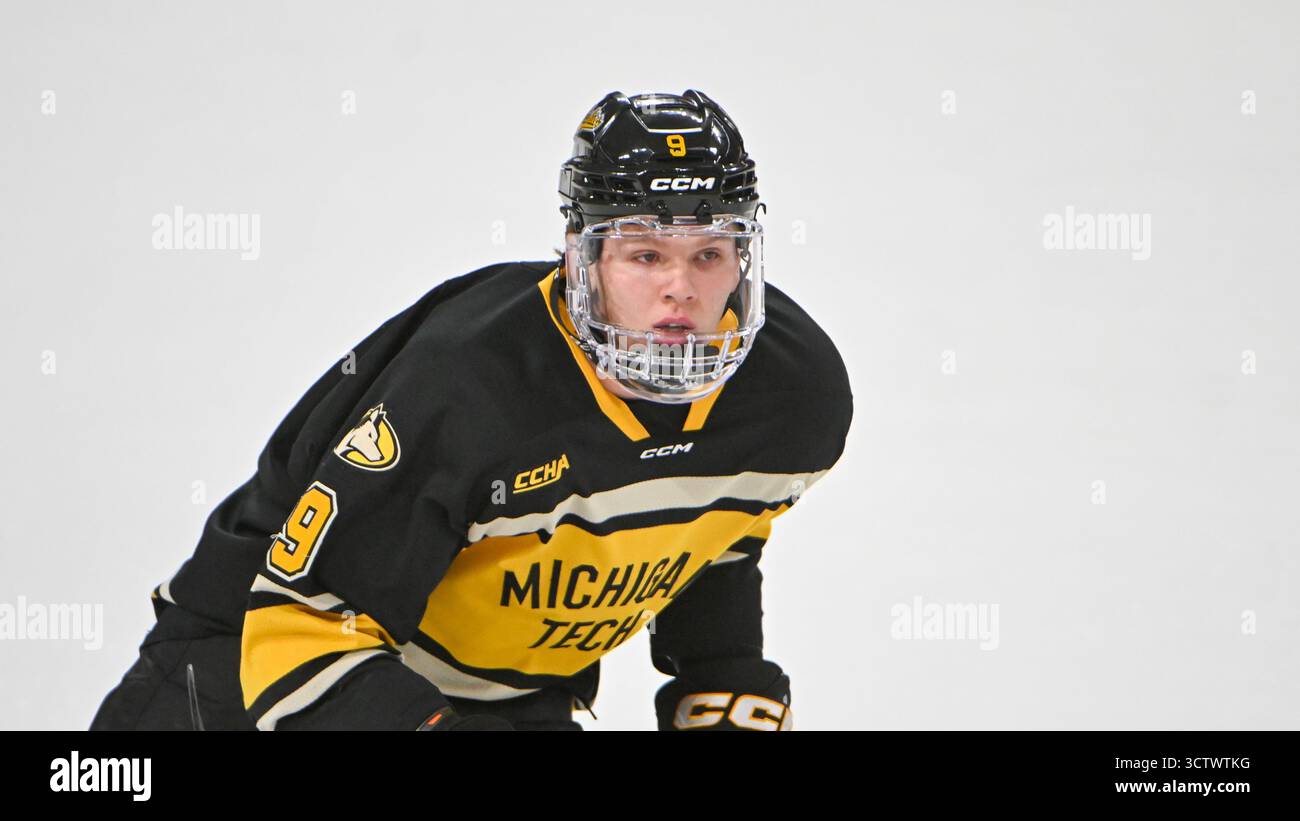 Michigan Tech forward Carson Latimer skates to the puck against ...