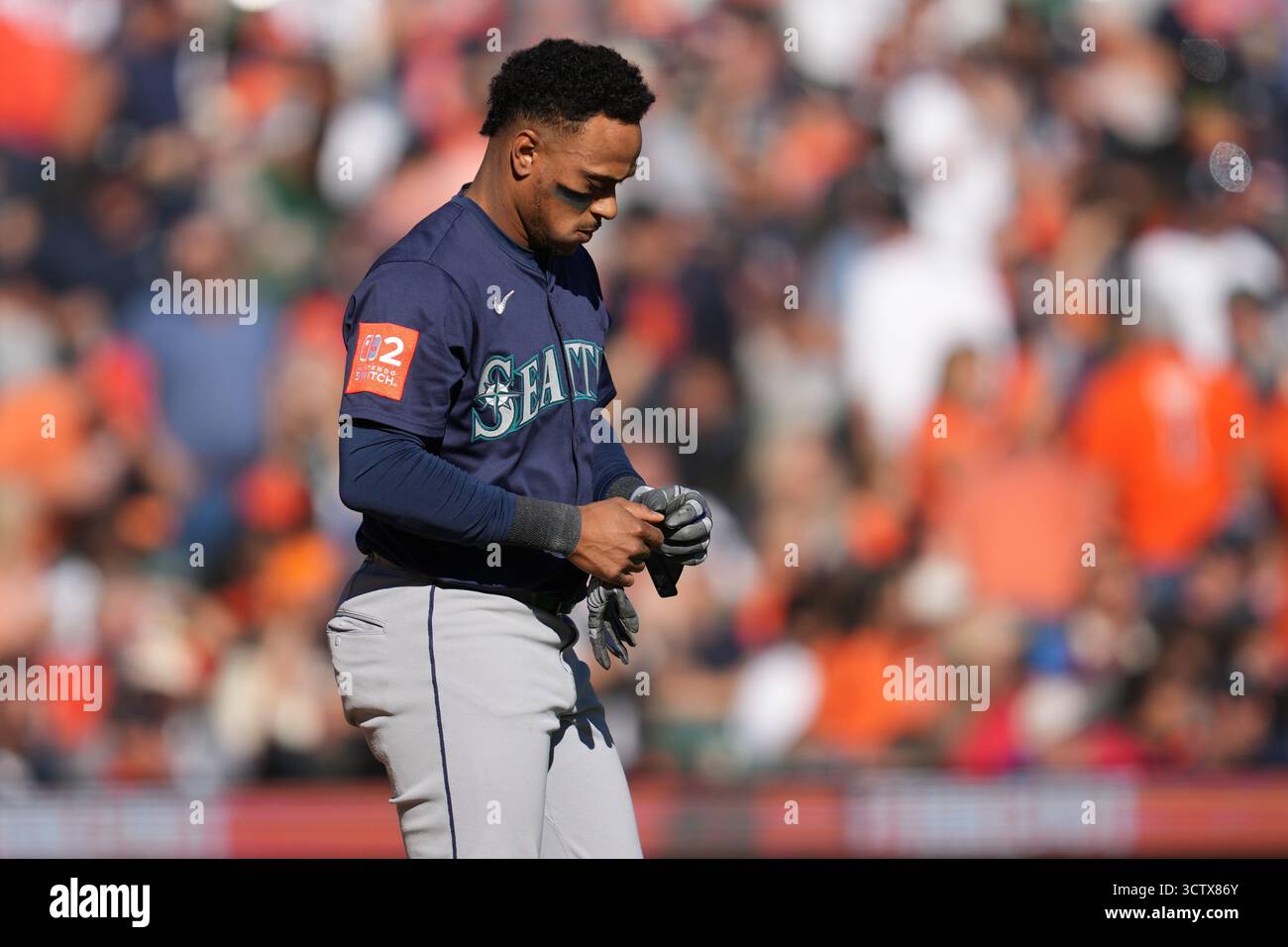 Seattle Mariners' Jorge Polanco takes off his batting gloves after ...