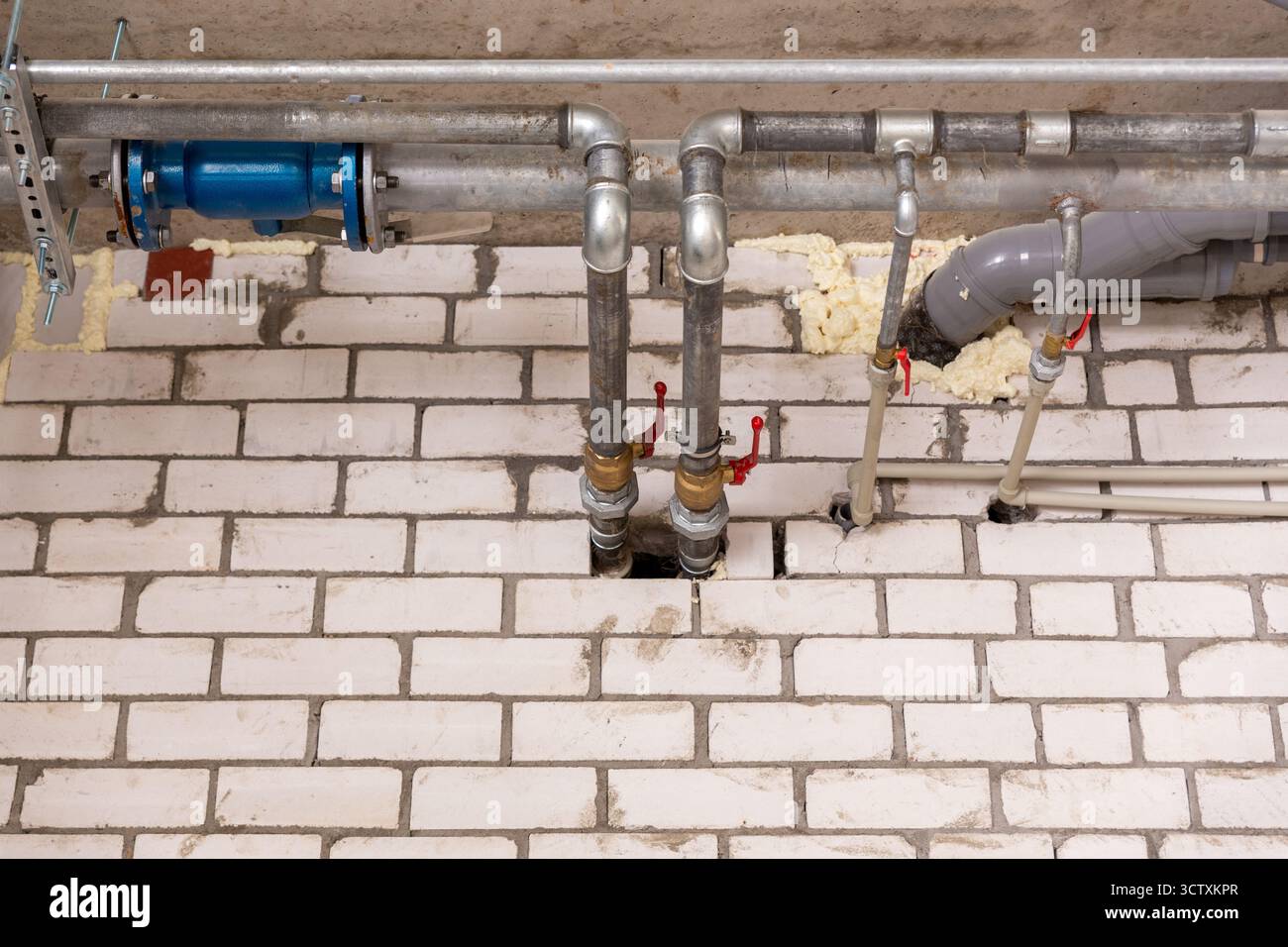 Overhead industrial plumbing and heating system with a network of metal ...