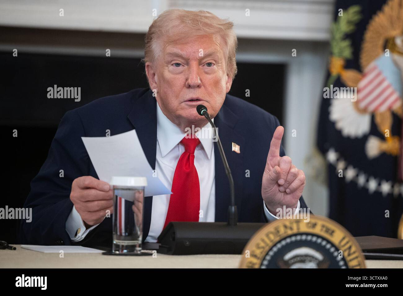 President Donald Trump holds a note from Secretary of State Marco Rubio ...