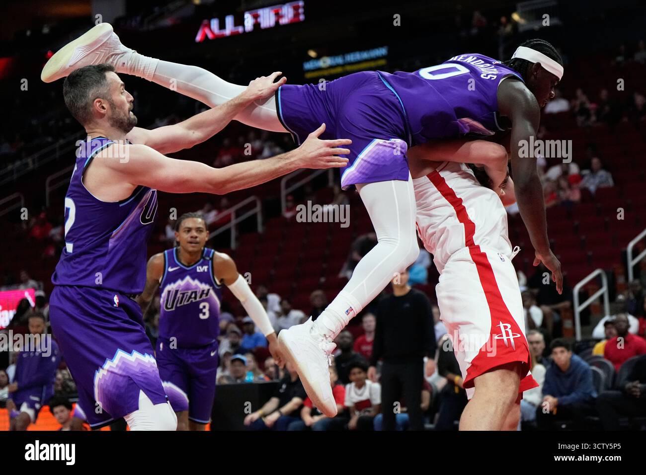 Utah Jazz forward Taylor Hendricks (0) falls on top of Houston Rockets ...