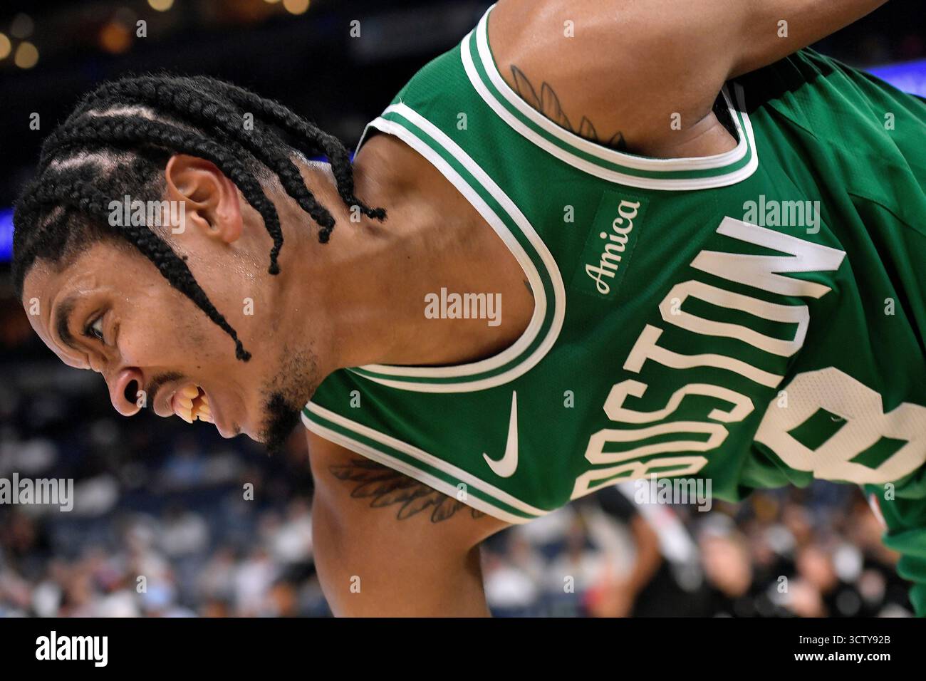 Boston Celtics forward Josh Minott struggles to his feet after falling ...