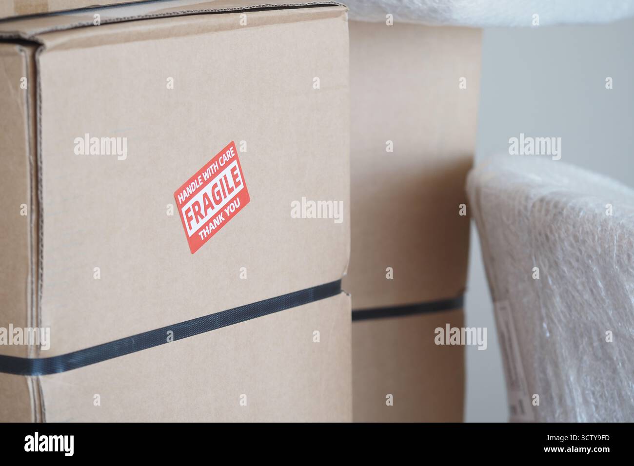 Shipping boxes ready for delivery with fragile stickers Stock Photo - Alamy