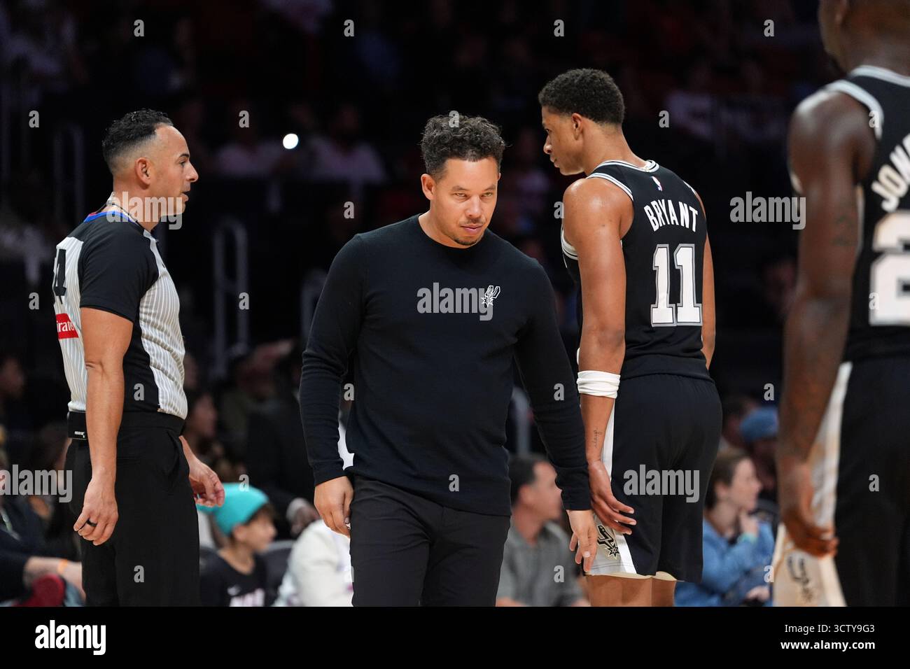 San Antonio Spurs Head Coach Mitch Johnson taps the leg of forward ...