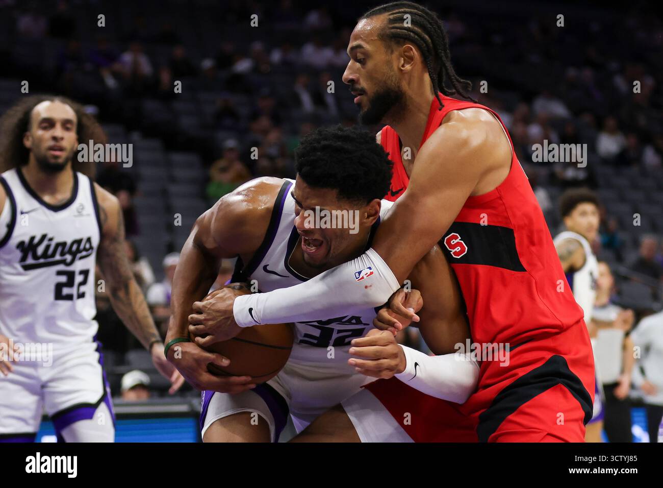 Sacramento Kings center Dylan Cardwell, left, and Toronto Raptors ...