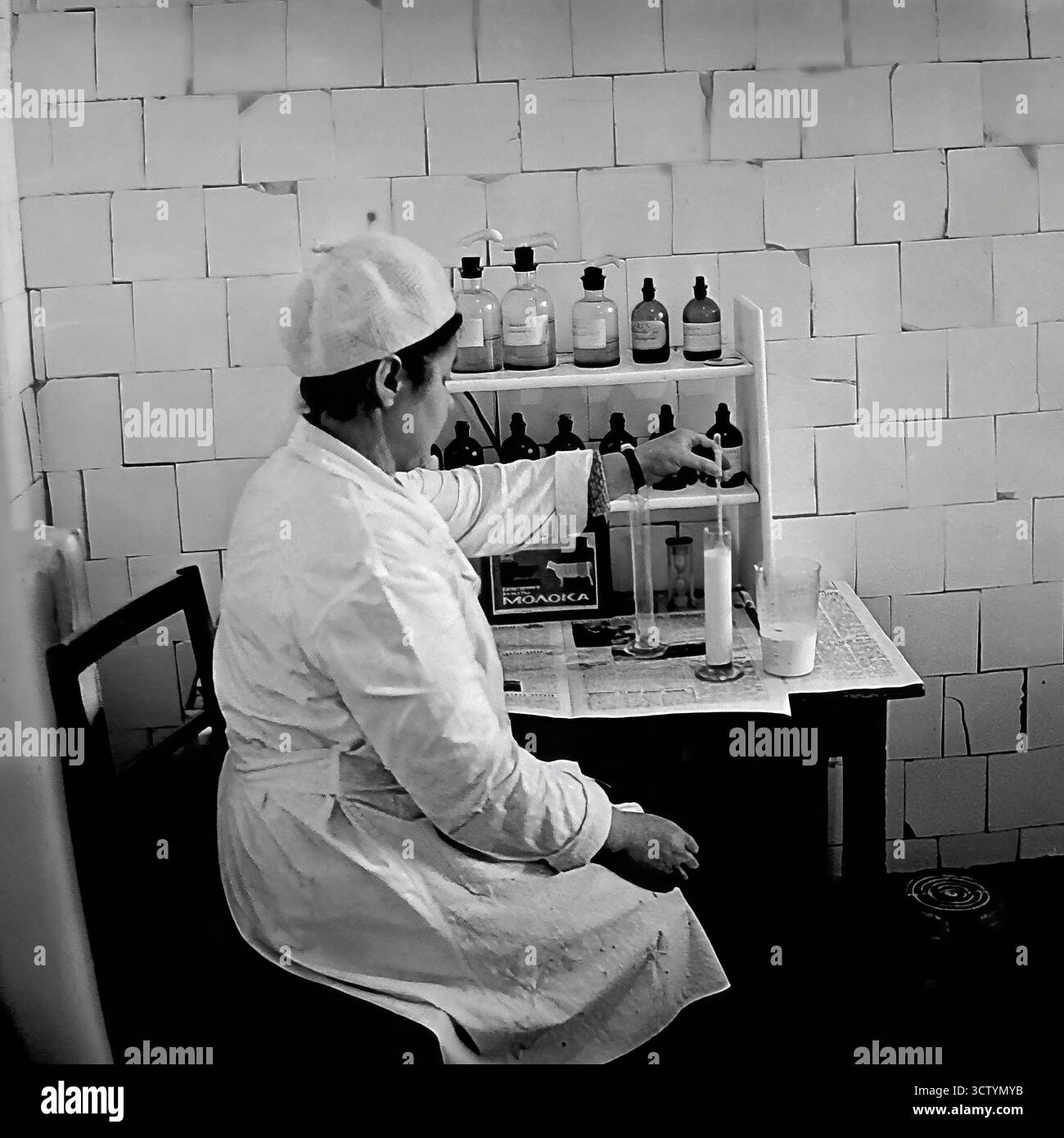 A black and white archival photo from the 1970s shows a female lab ...