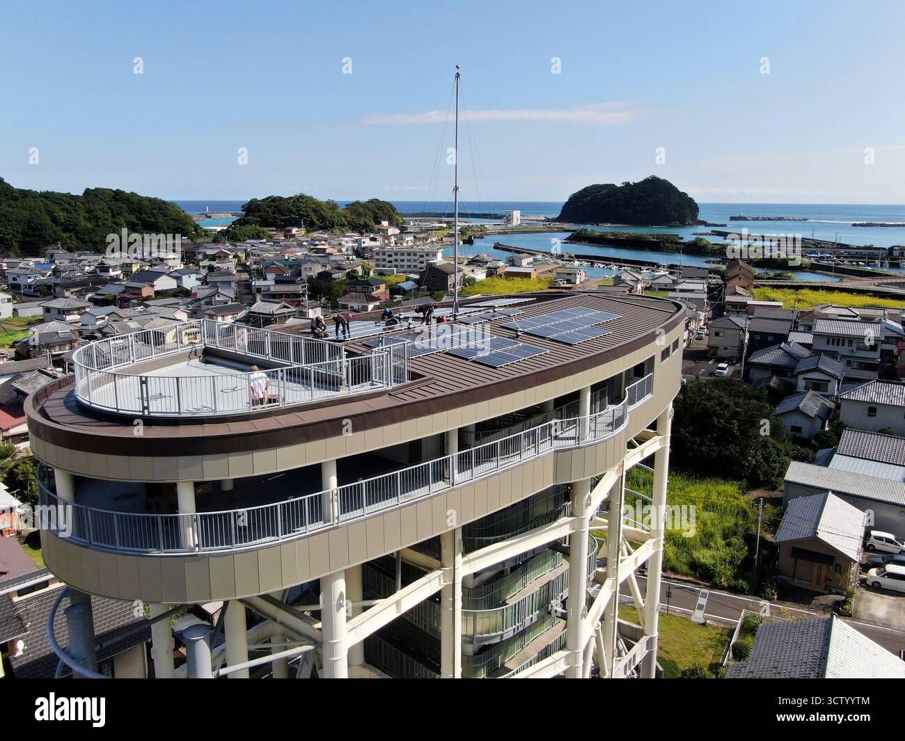 Solar panels are installed on the roof of a tsunami evacuation tower in ...