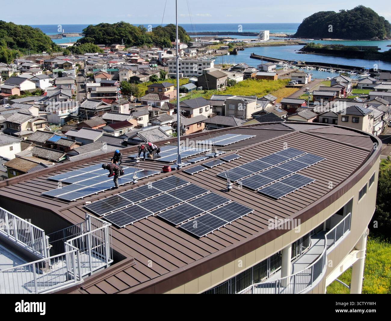 Solar panels are installed on the roof of a tsunami evacuation tower in ...